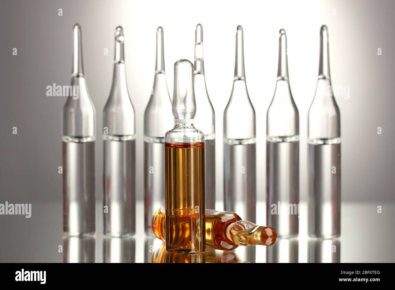 medical ampules on grey background Stock Photo - Alamy