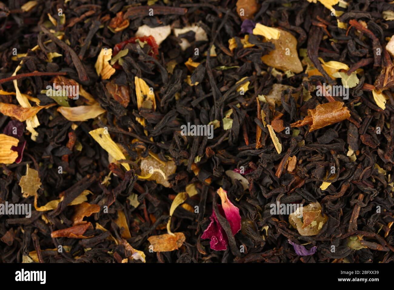 aromatic black dry tea with fruits and petals, close up Stock Photo - Alamy