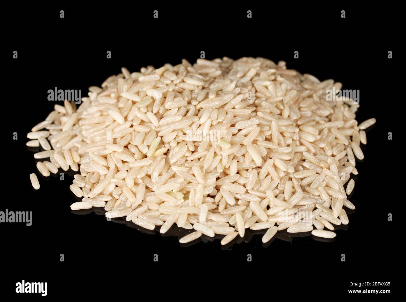 White unpolished rice isolated on black Stock Photo - Alamy