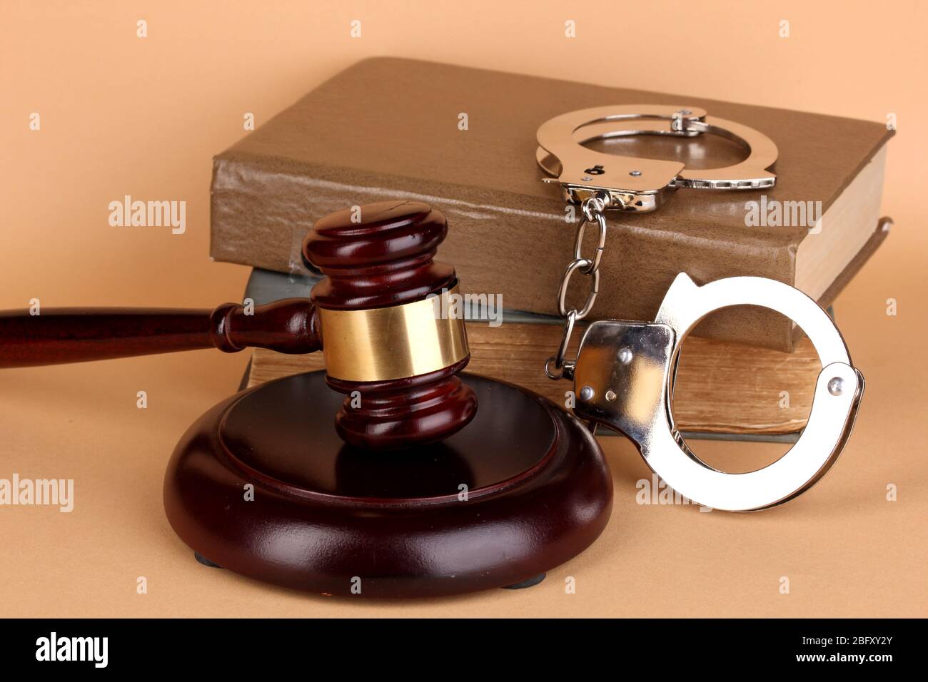 Gavel, handcuffs andbook on law on beige background Stock Photo - Alamy