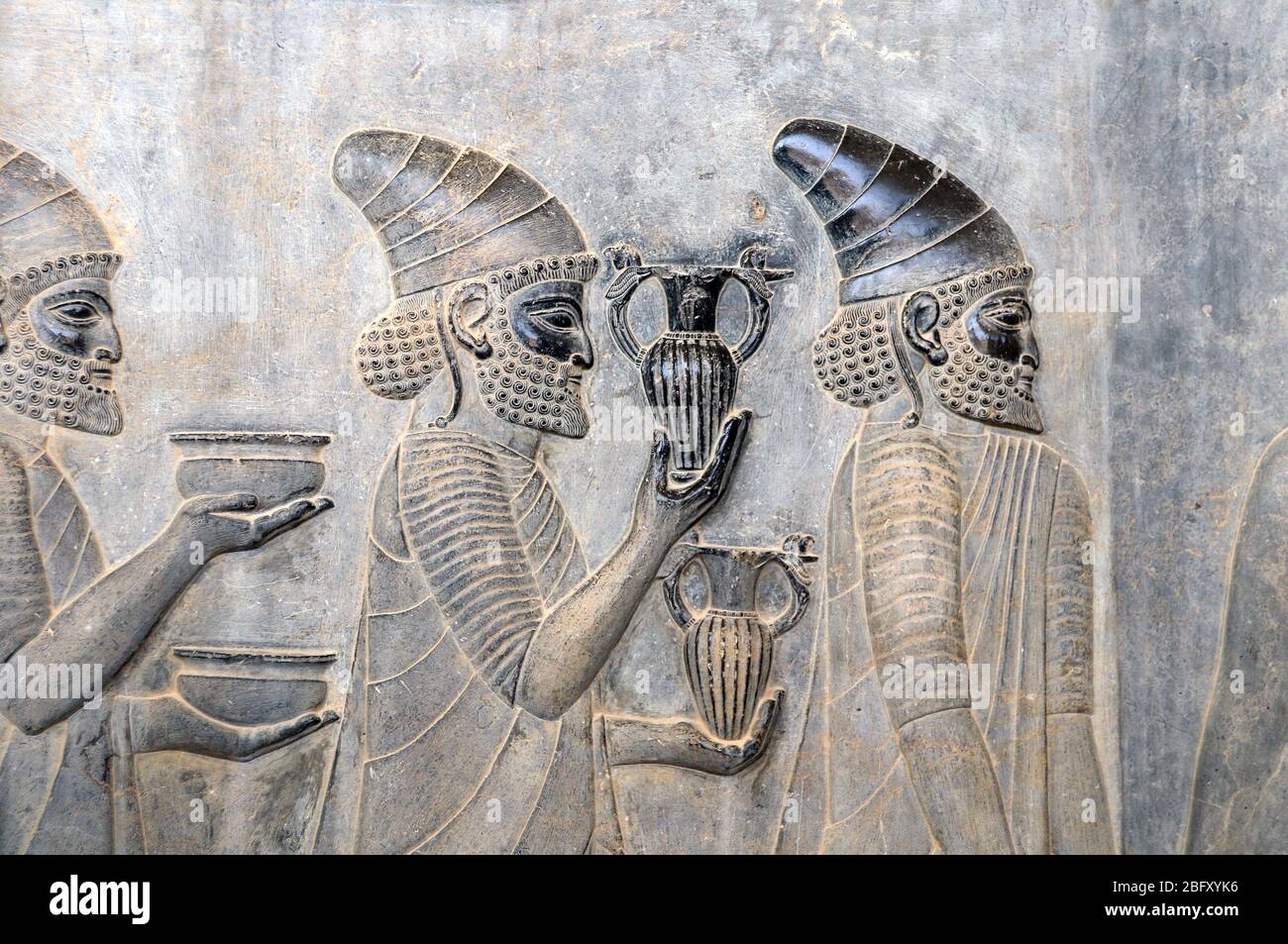 Ancient wall with bas-relief with foreign ambassadors with gifts and ...