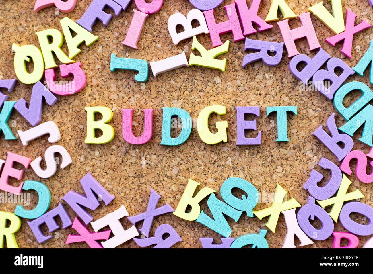 Color alphabet in word budget with another letter as frame on cork ...