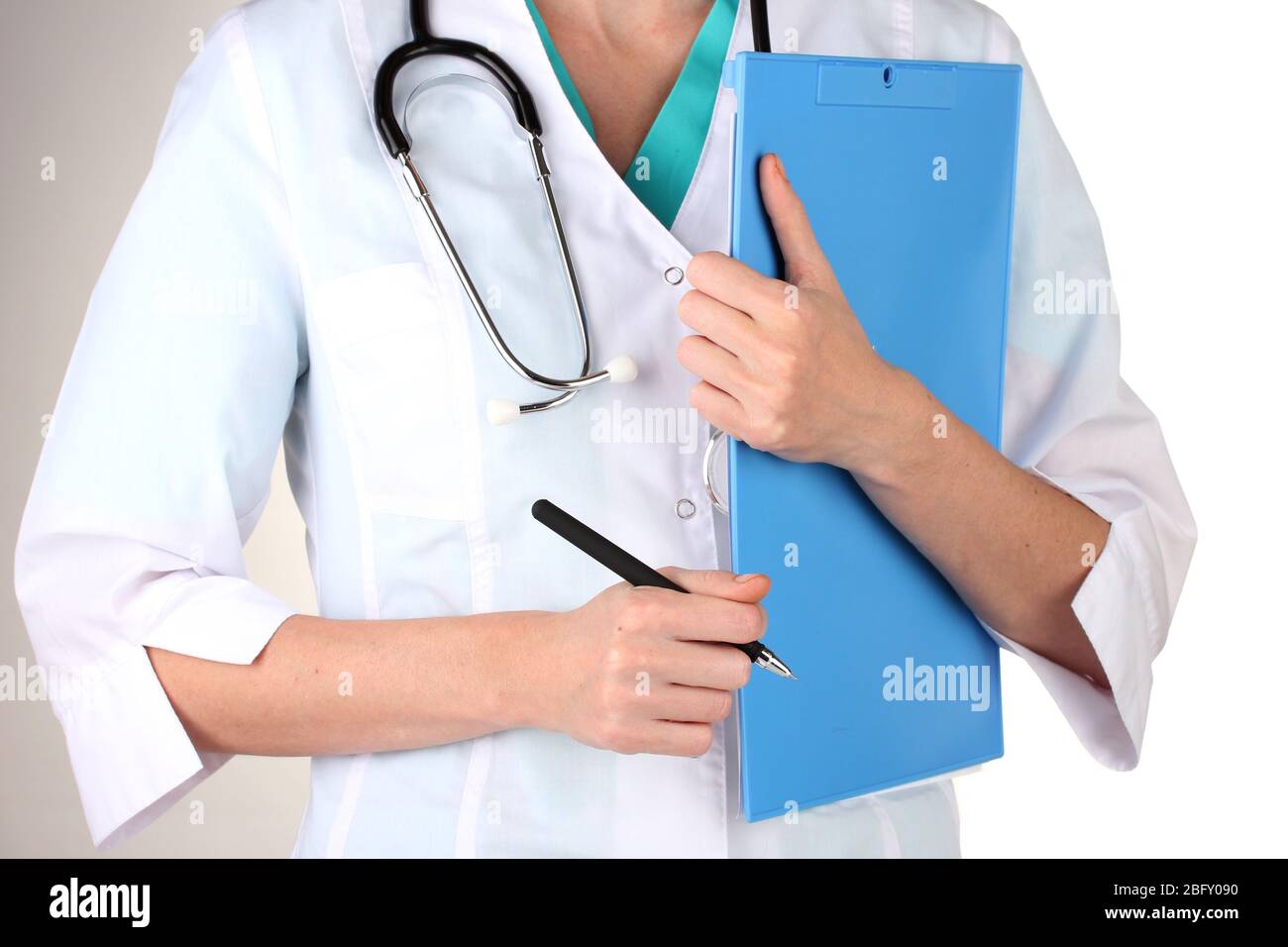 Hand of doctor with pen writing on prescription blank isolated on white ...