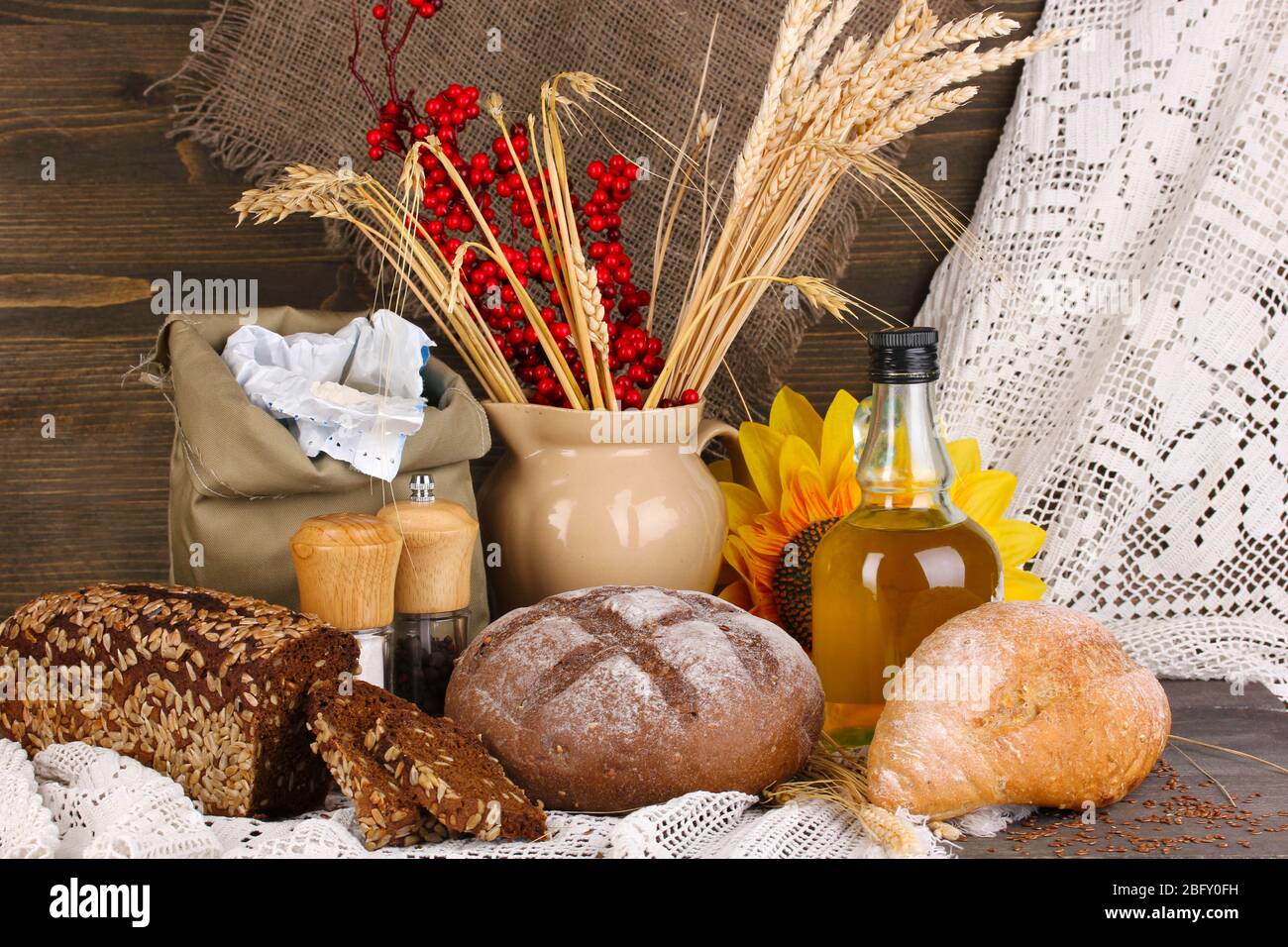 Different types of rye bread on wooden table on autumn composition ...