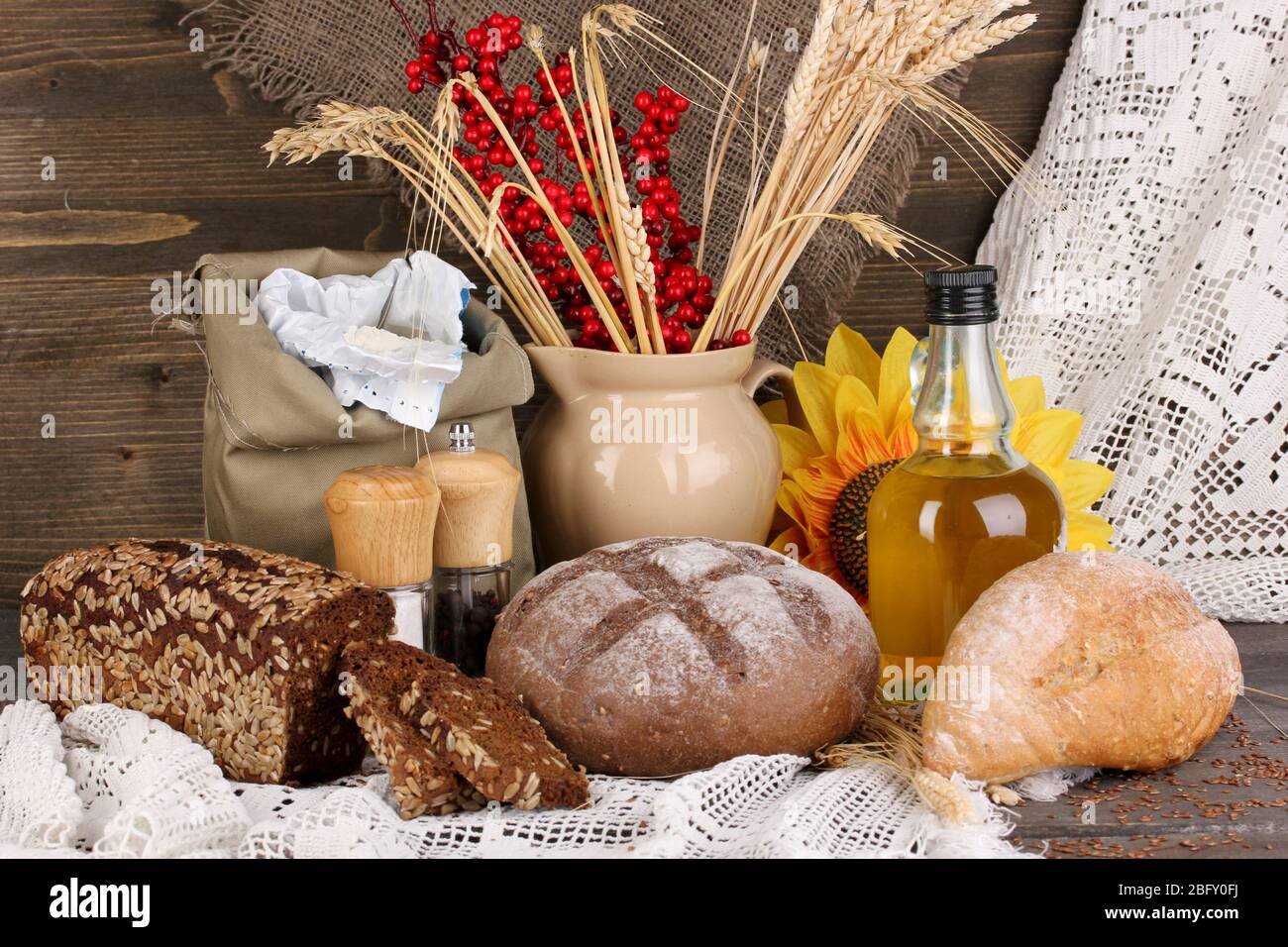 Different types of rye bread on wooden table on autumn composition ...