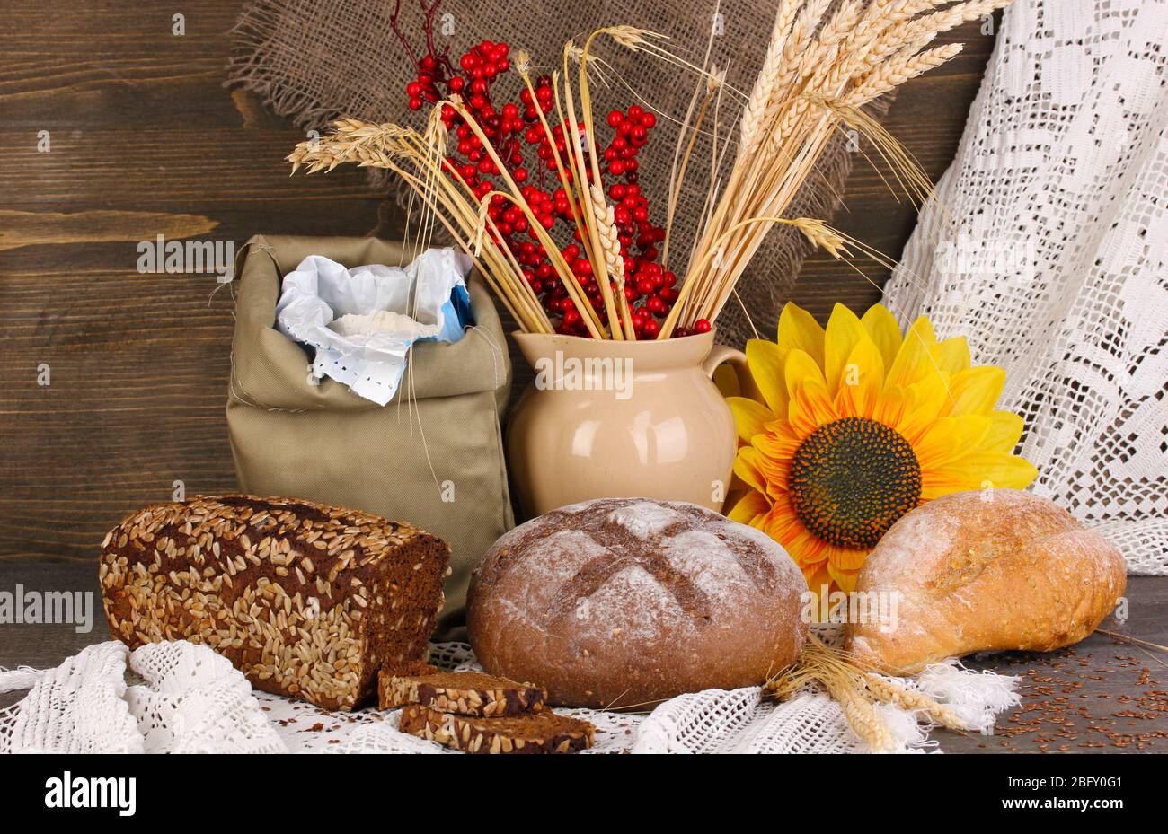 Different types of rye bread on wooden table on autumn composition ...
