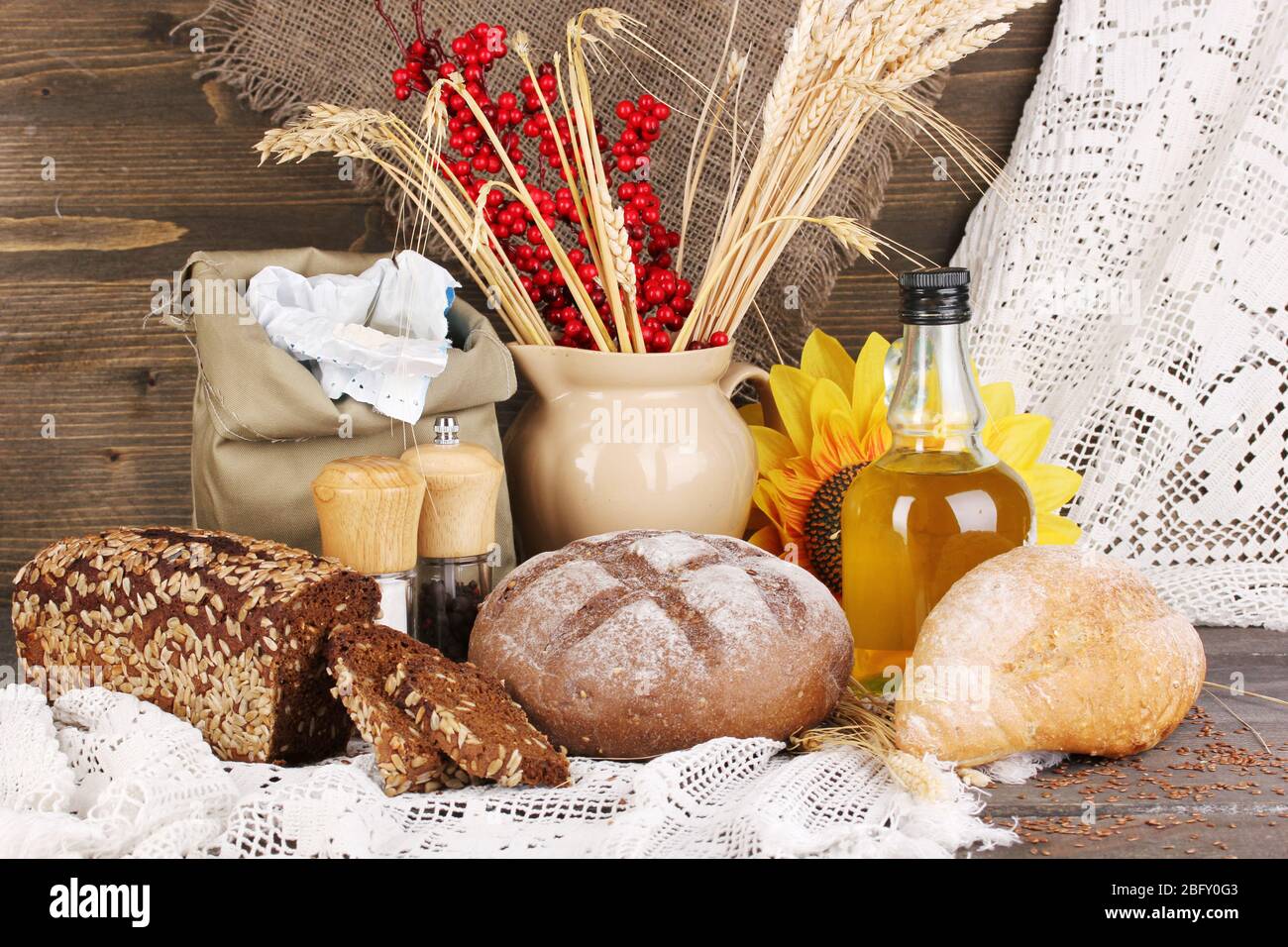 Different types of rye bread on wooden table on autumn composition ...