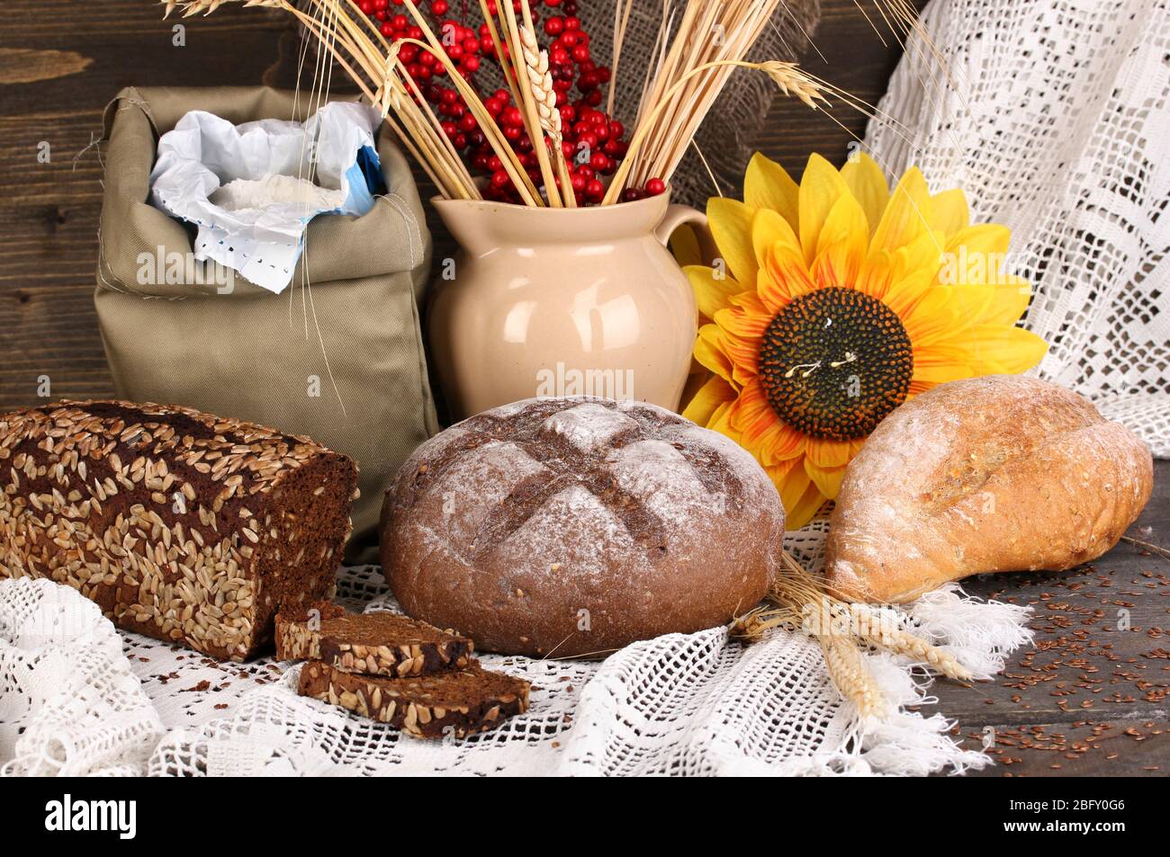 Different types of rye bread on wooden table on autumn composition ...