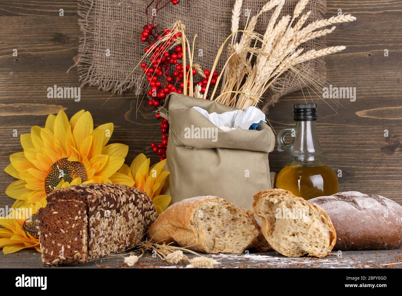 Different types of rye bread on wooden table on wooden background Stock ...