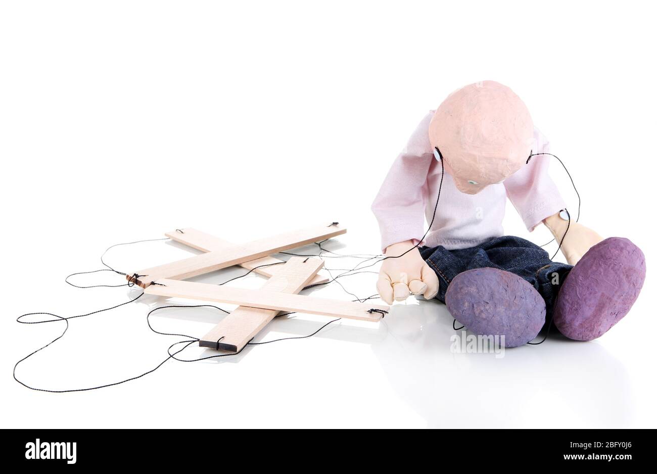 Wooden puppet sitting isolated on white Stock Photo - Alamy