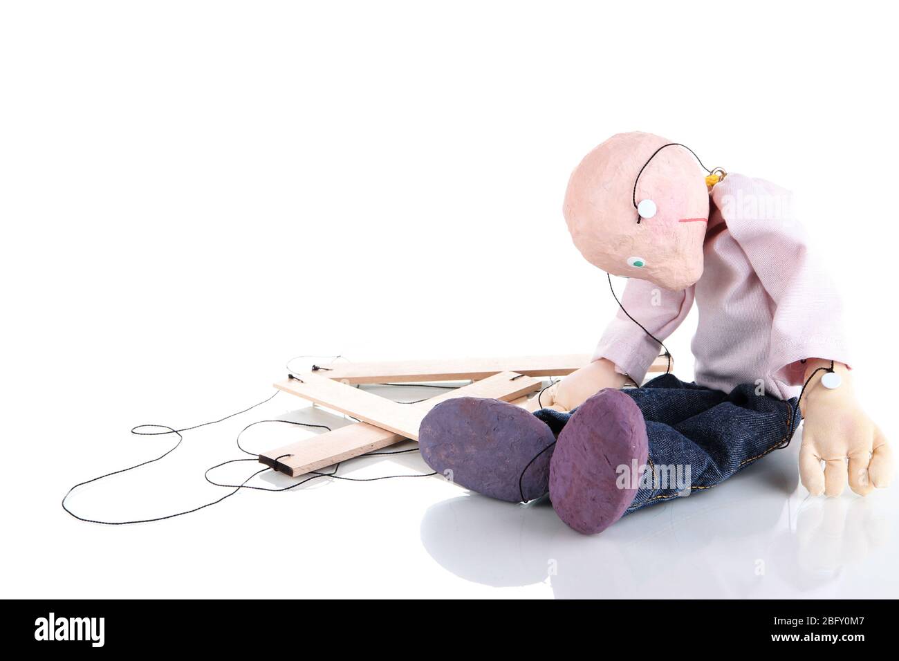 Wooden puppet sitting isolated on white Stock Photo - Alamy