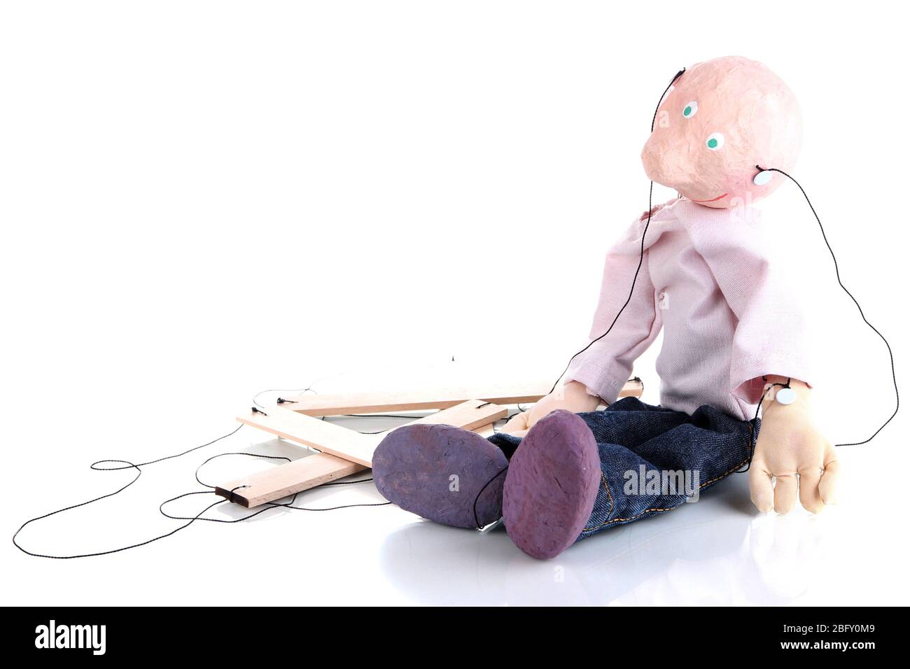 Wooden puppet sitting isolated on white Stock Photo - Alamy