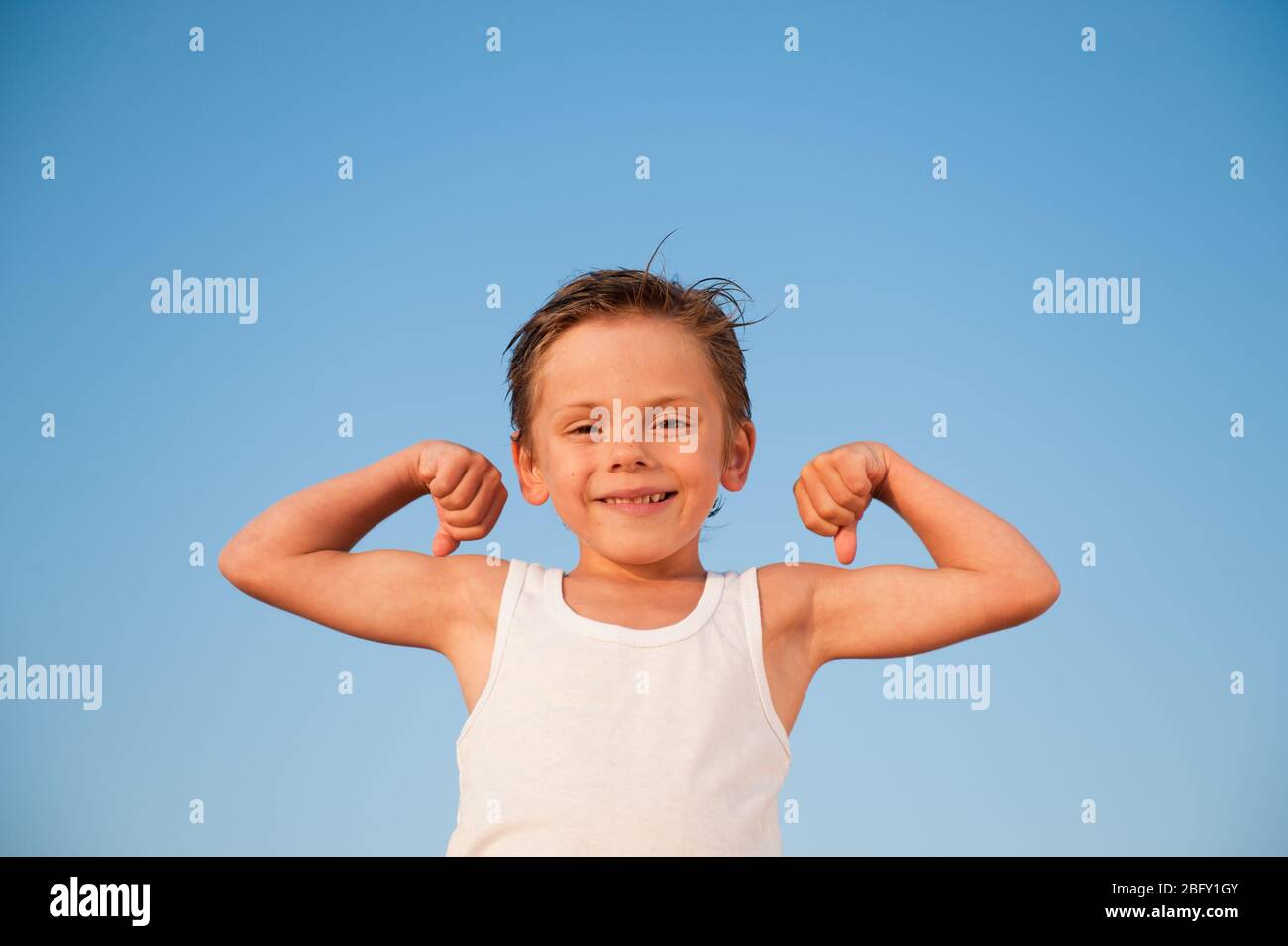 happy healthy little athlete kid on blue sky background Stock Photo - Alamy