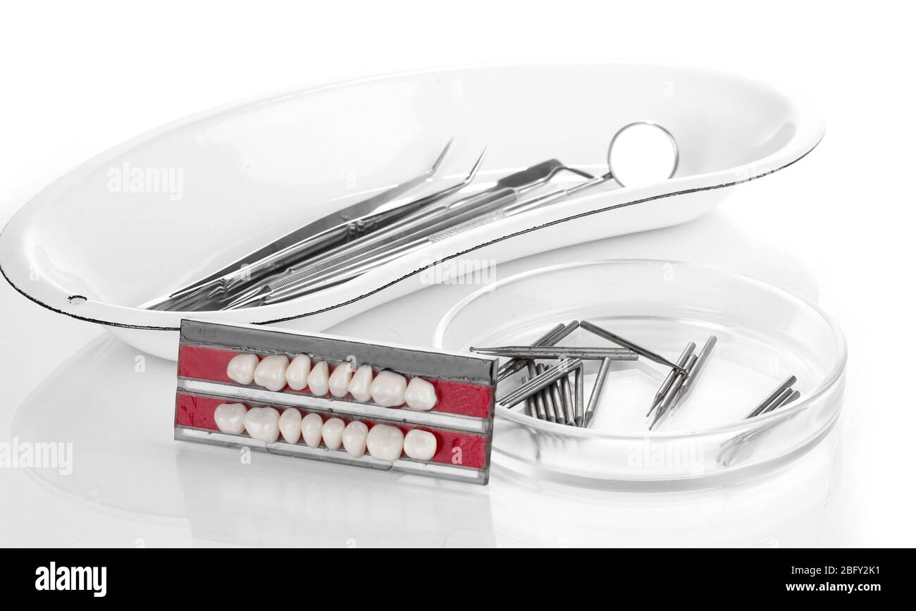 denture with dental tools isolated on white Stock Photo - Alamy