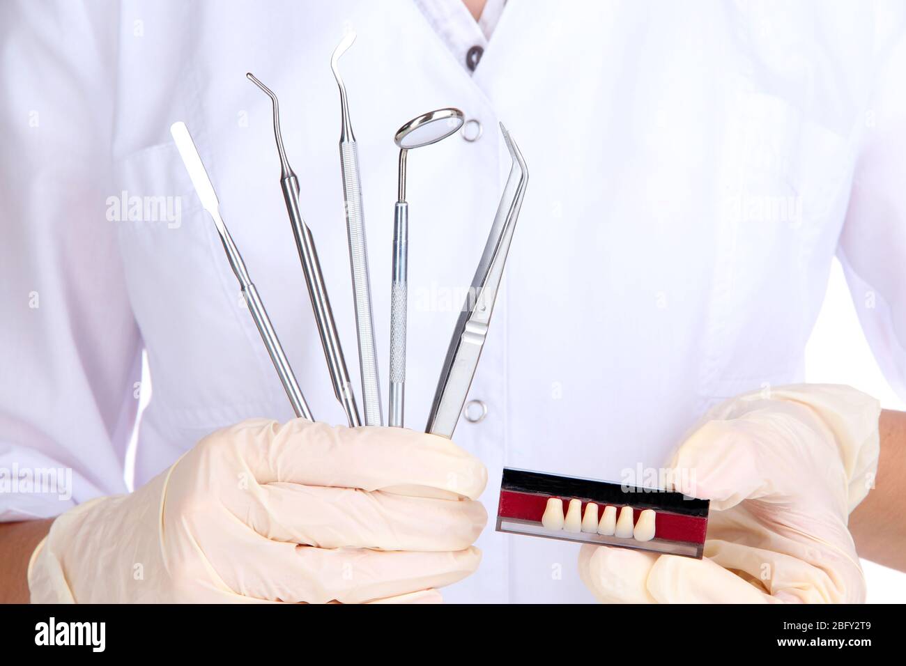 Set of dental tools and denture in dentists hands Stock Photo - Alamy