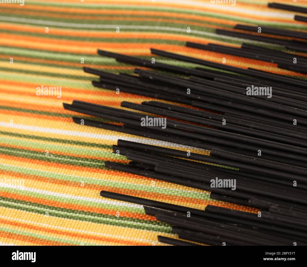 Black spaghetti on light background Stock Photo - Alamy
