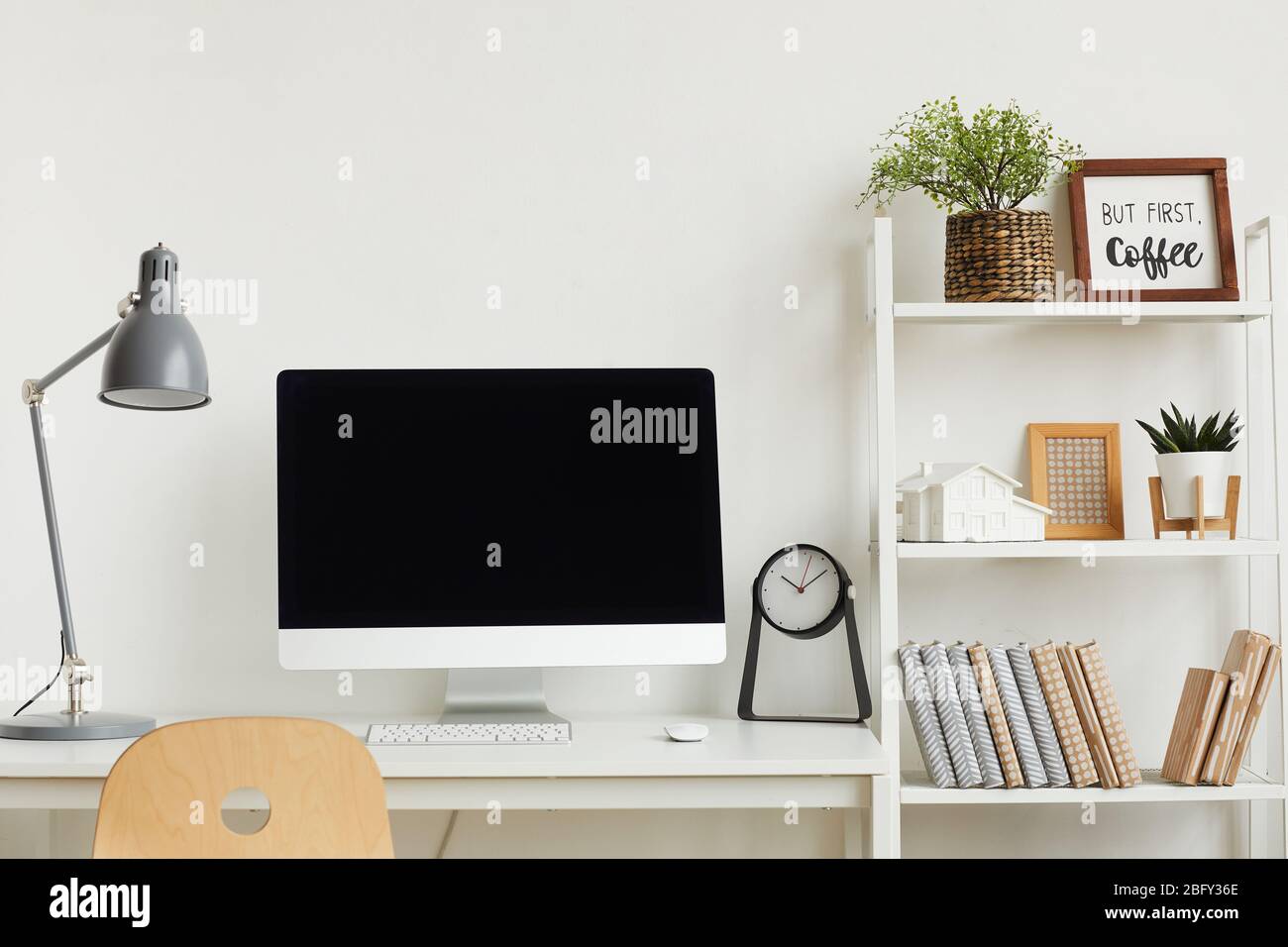 Background image of modern computer on desk against white wall in home ...