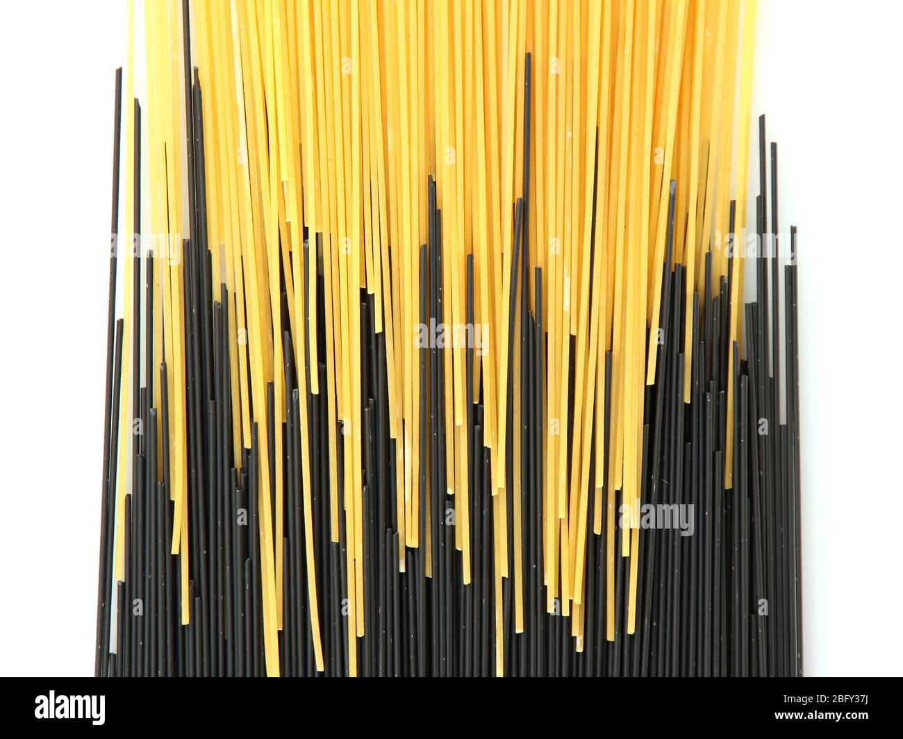 Black and yellow spaghetti isolated on white Stock Photo - Alamy