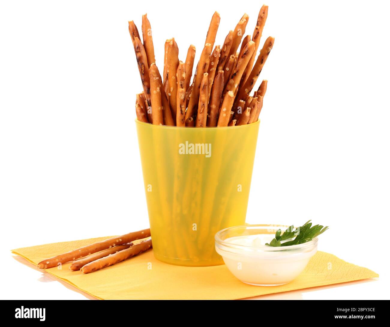 Tasty crispy sticks in yellow plastic cup isolated on white Stock Photo ...