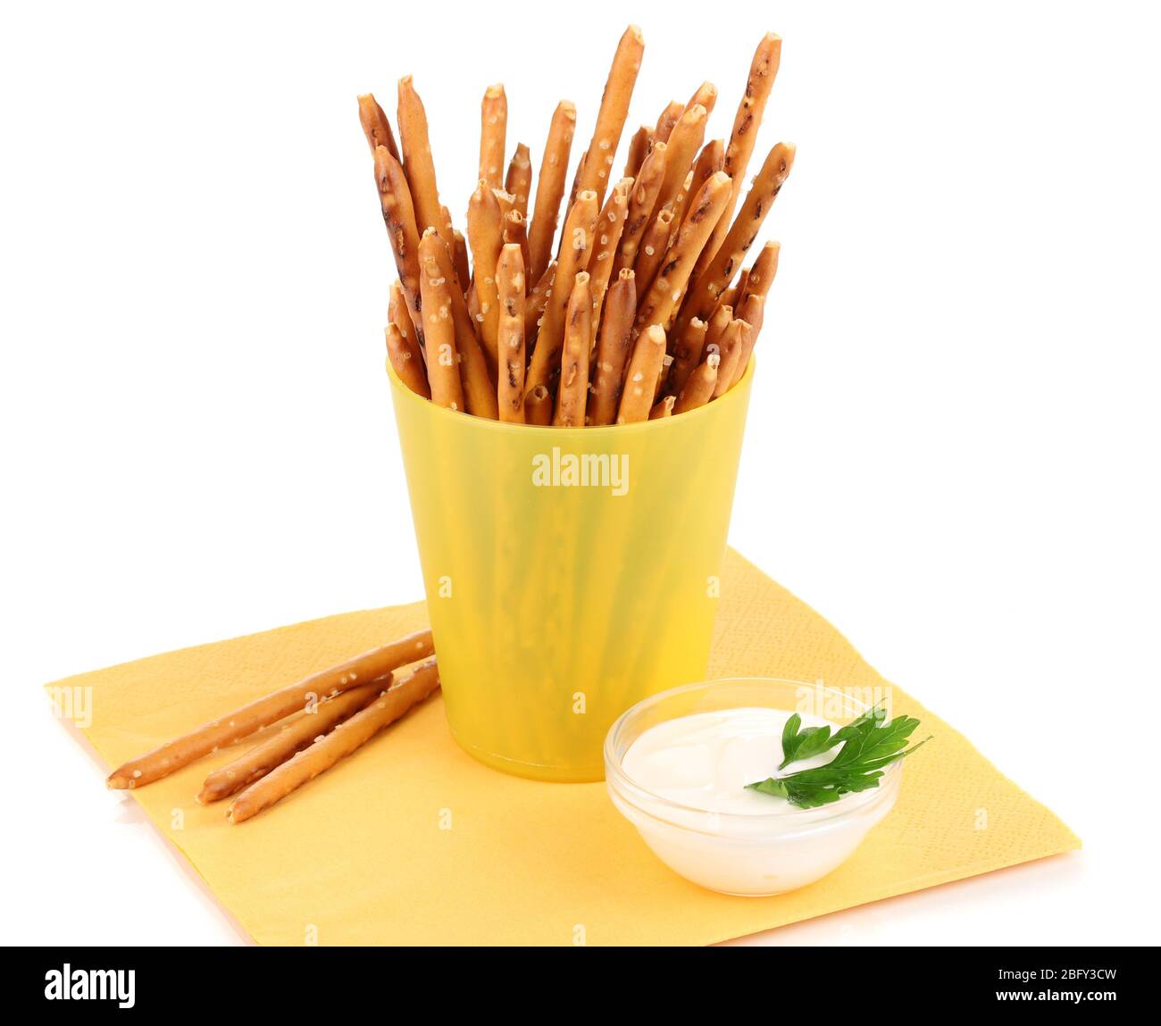 Tasty crispy sticks in yellow plastic cup isolated on white Stock Photo ...