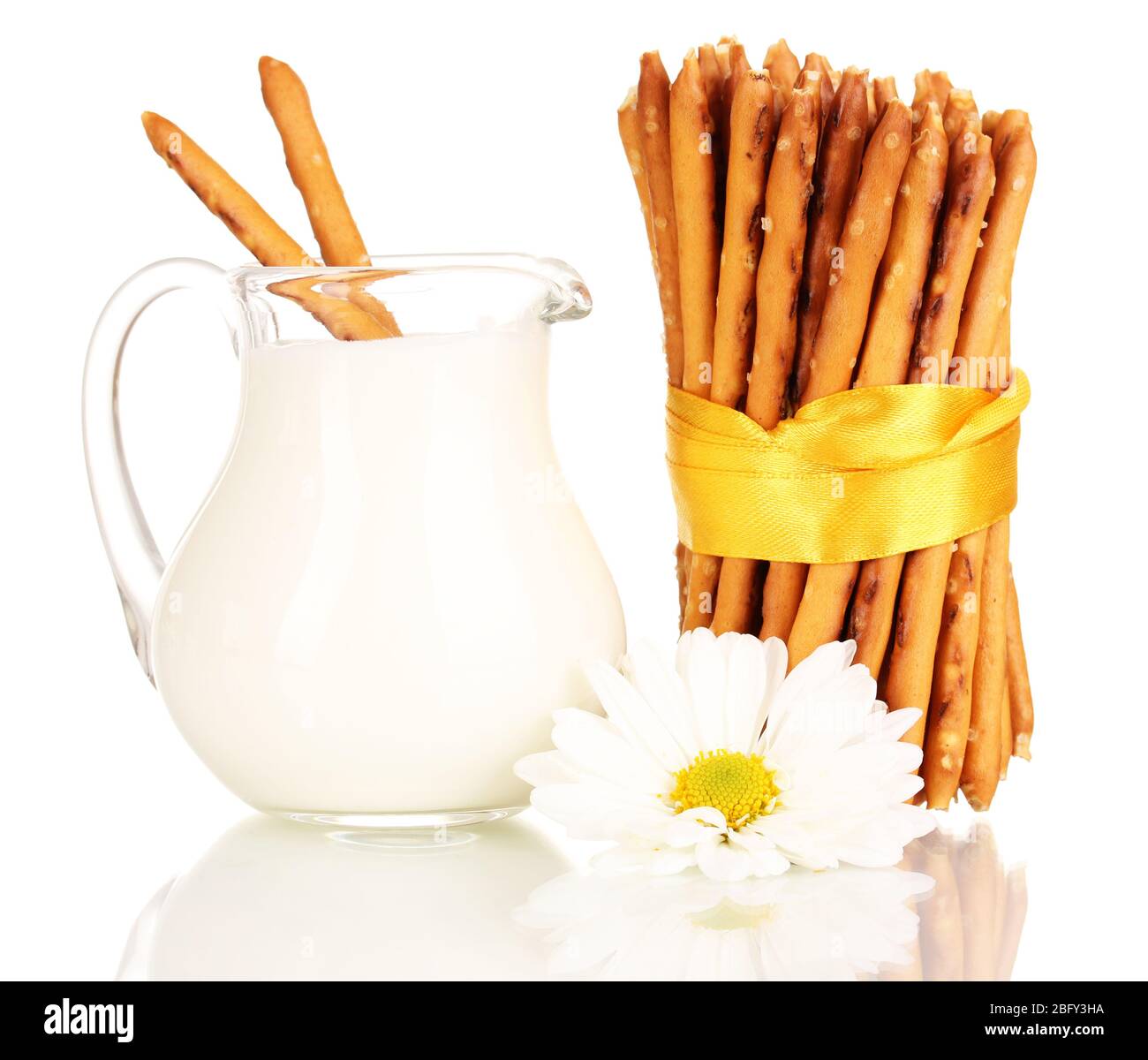 Tasty crispy sticks with pitcher with sour cream isolated on white ...