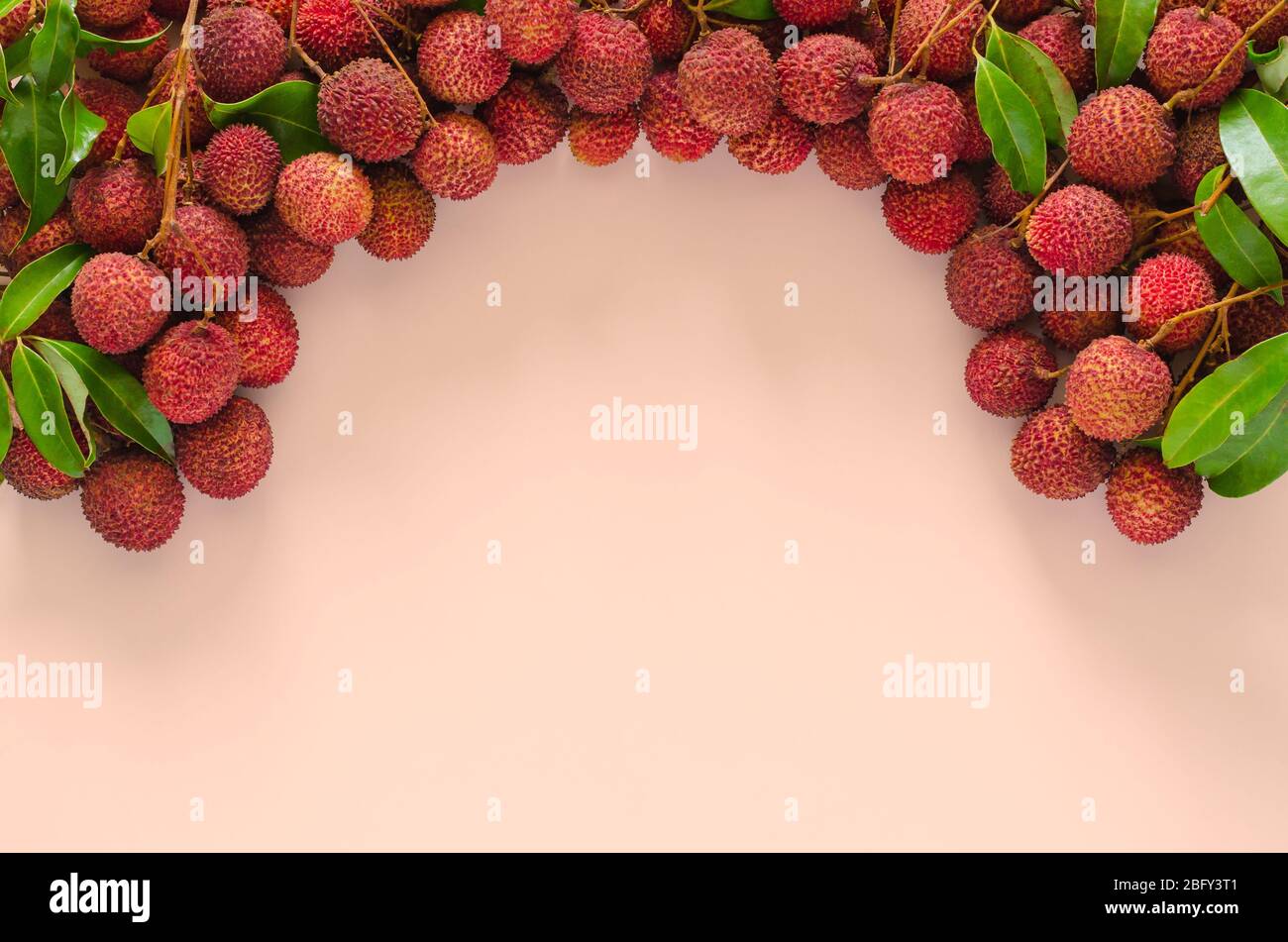 Fresh lychee fruits with leaves on beige color background. Top view ...