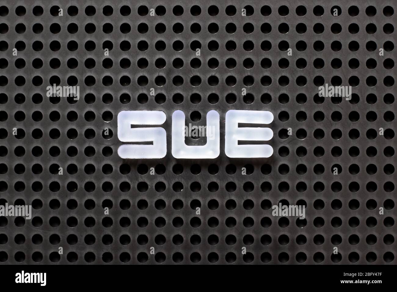 Black color pegboard with white letter in word sue Stock Photo - Alamy