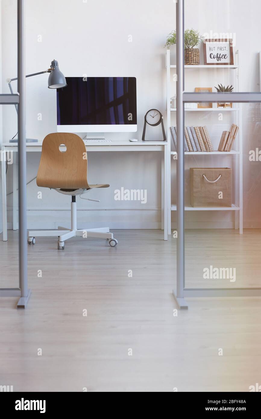 Vertical background image of empty office workplace behind glass wall ...