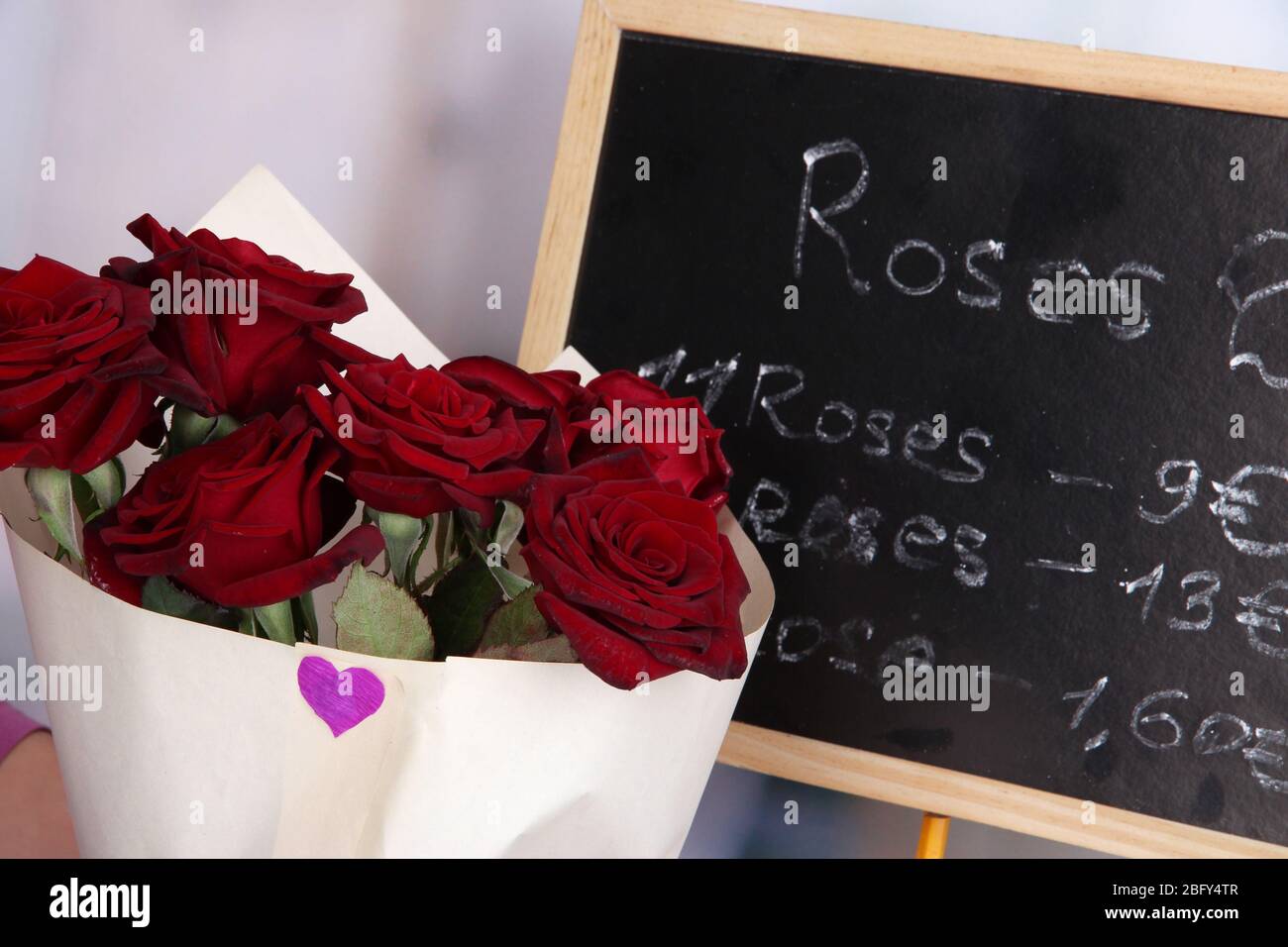 Wonderful bouquet of red roses with tablet on their selling Stock Photo ...