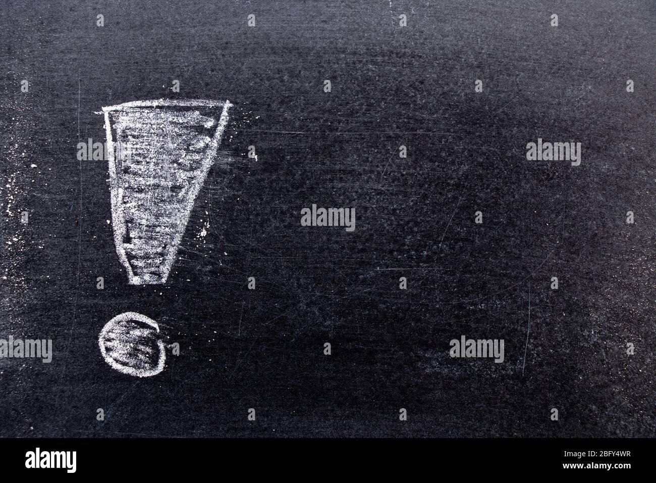 White color chalk hand drawing in exclamation mark with blank space ...