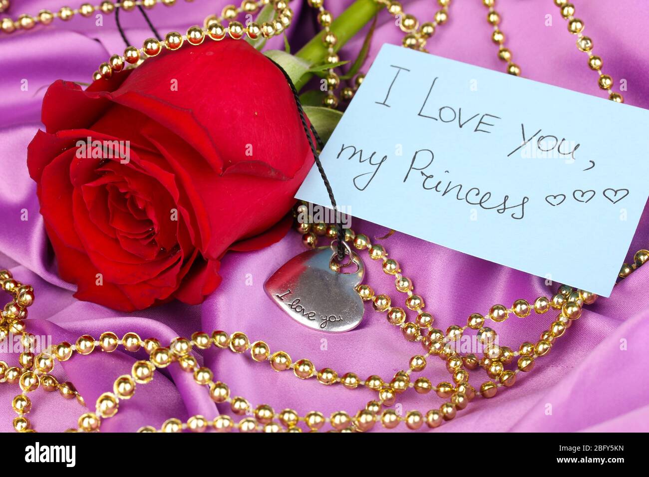 Heart pendant with red rose Stock Photo - Alamy