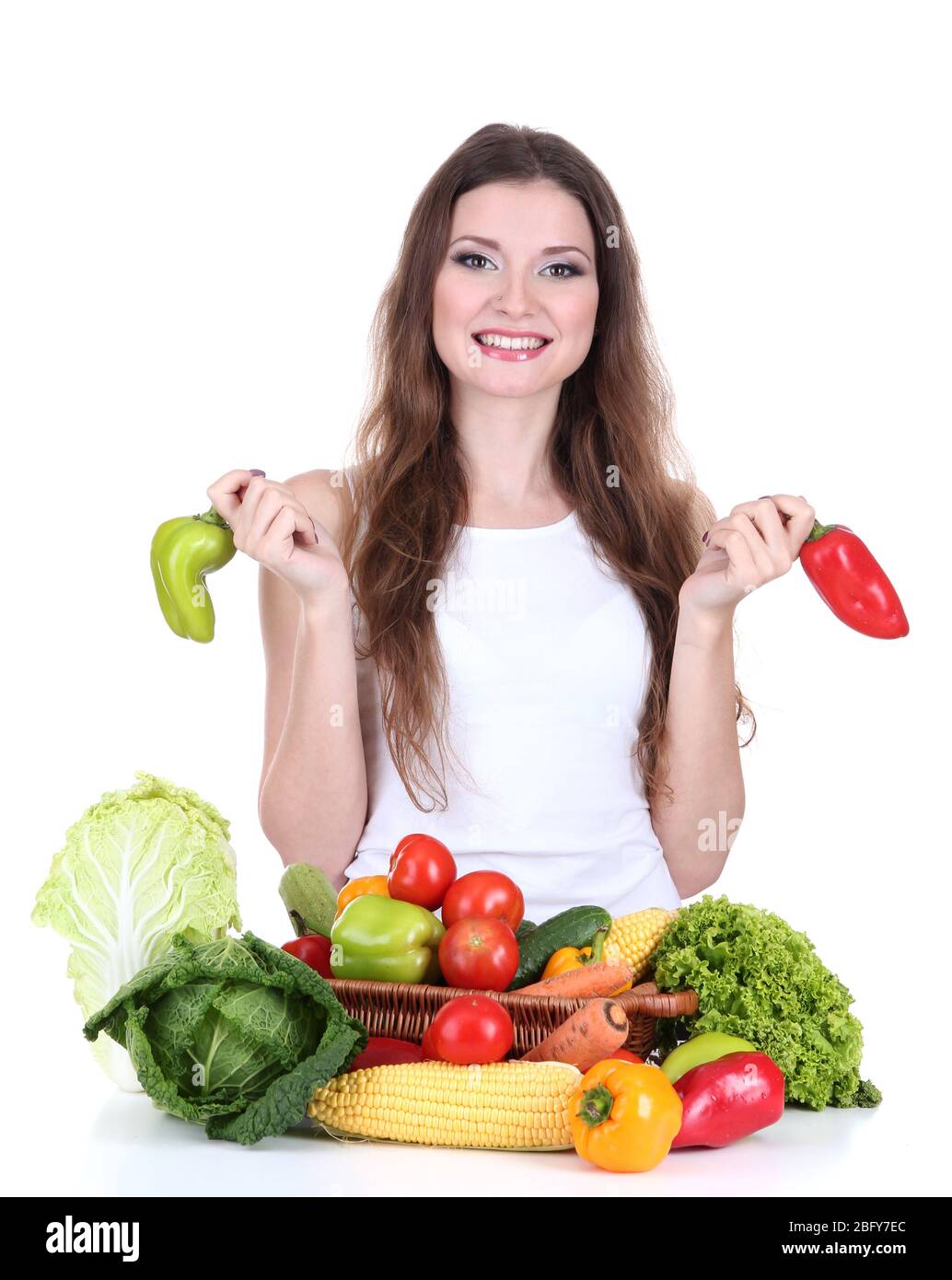 Beautiful woman with vegetables on table isolated on white Stock Photo ...