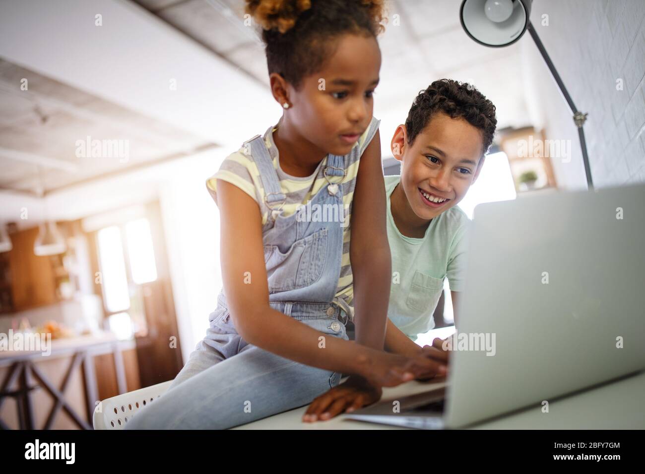 Game, study, fun concept. Happy children spending time with notebook ...