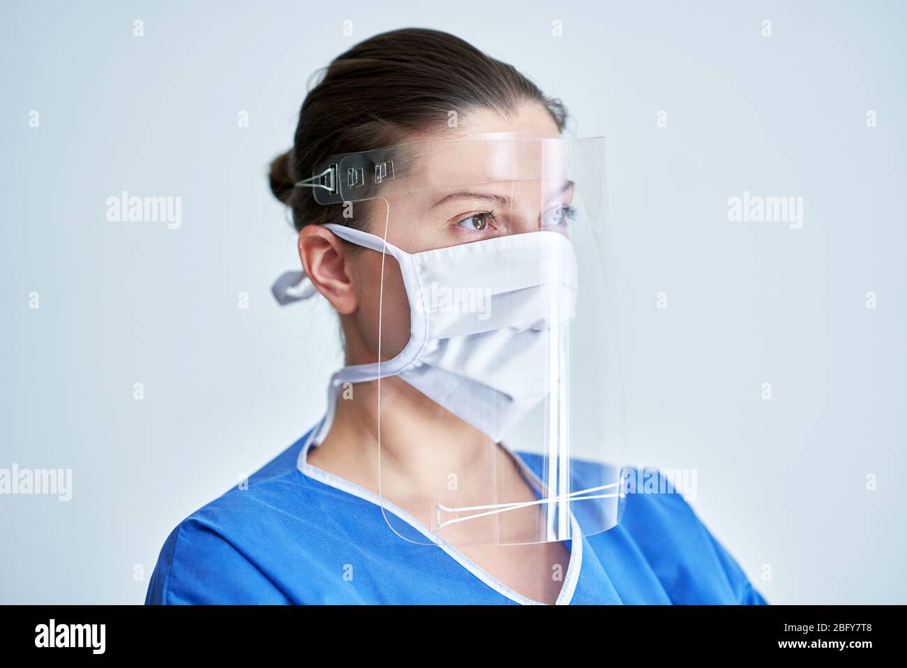 Portrait of female medical doctor wearing protective mask and face ...