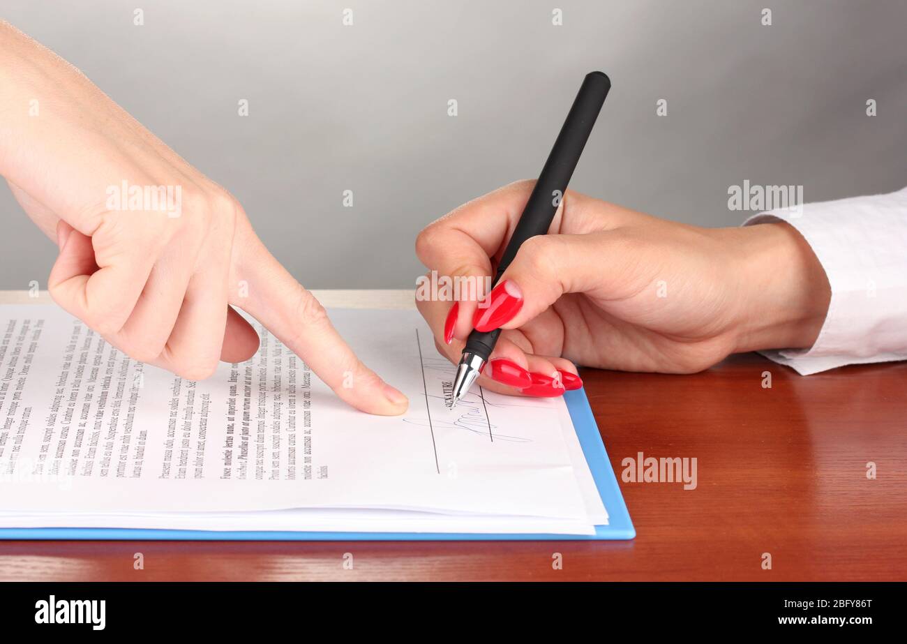 signing of treaty on wooden table on color background Stock Photo - Alamy