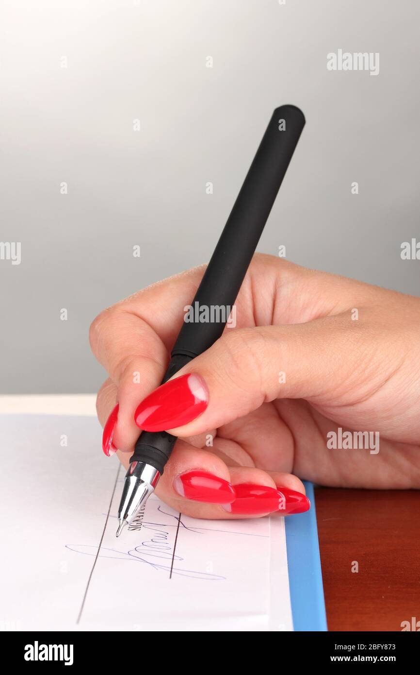 signing of treaty on wooden table on color background Stock Photo - Alamy