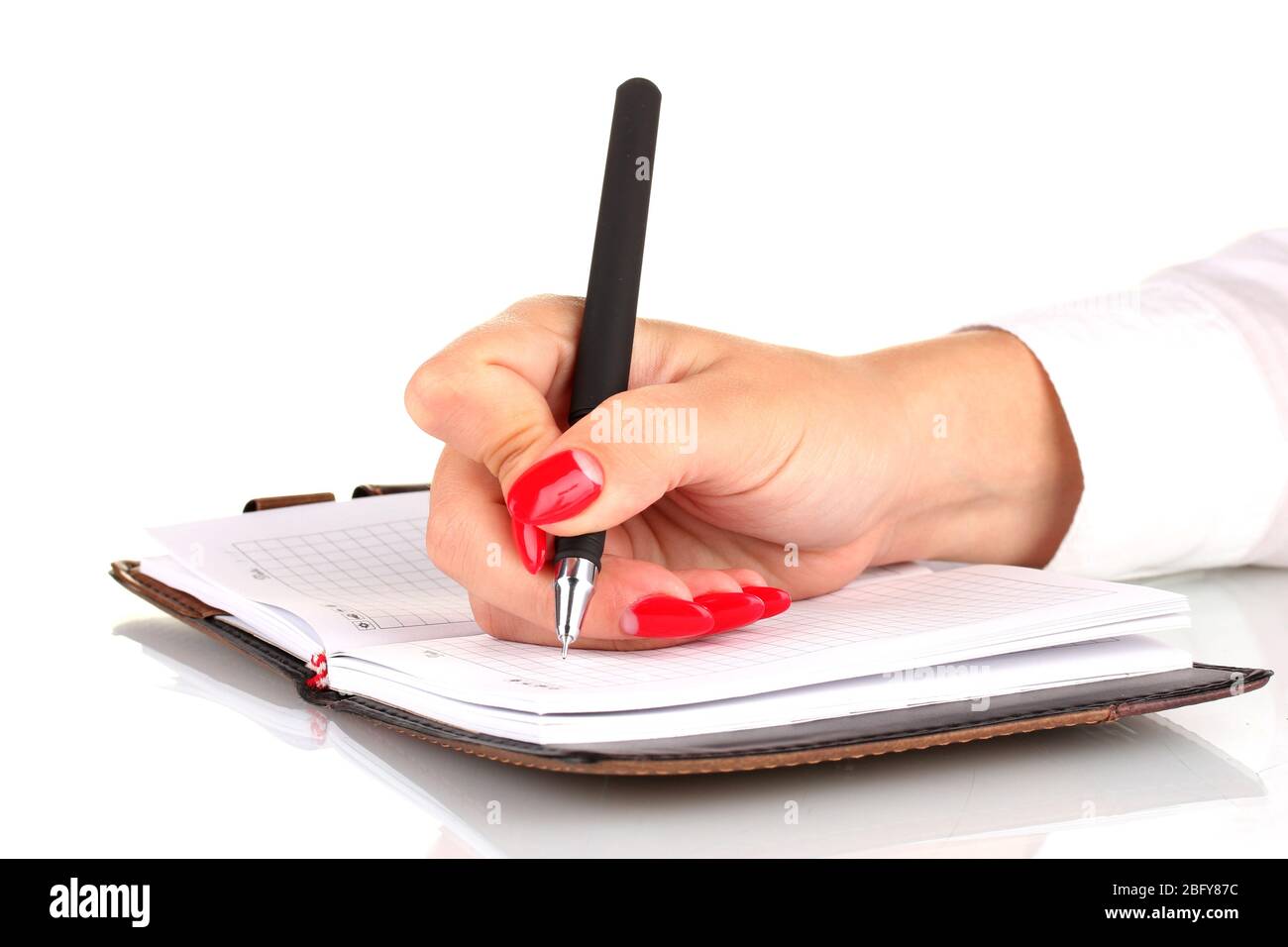Hand signing in notebook isolated on white Stock Photo - Alamy