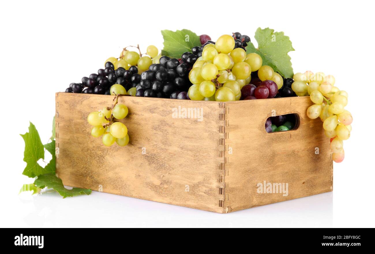 assortment of ripe sweet grapes in wooden crate, isolated on white ...