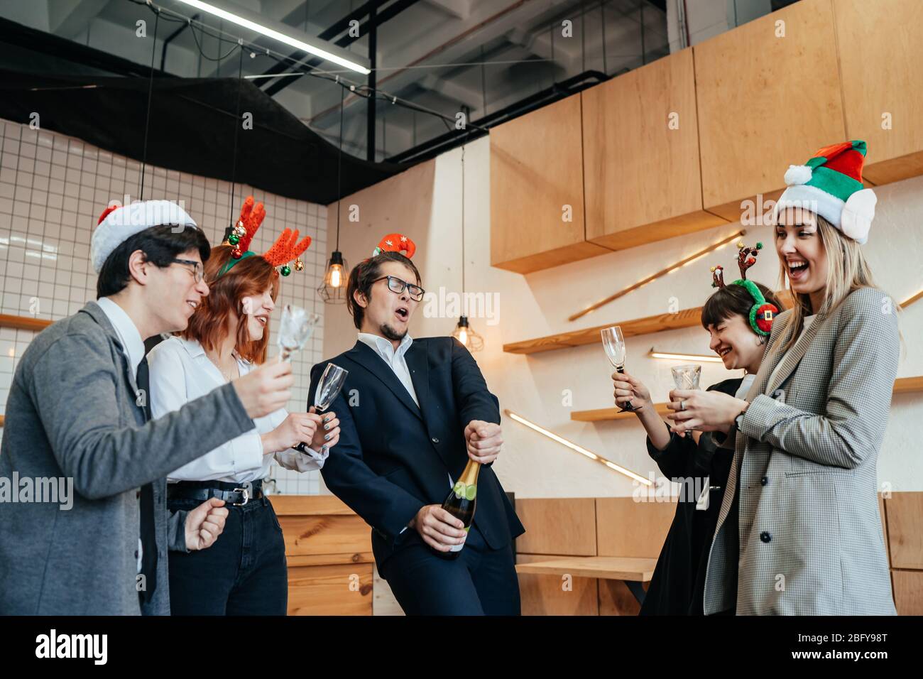 Happy colleagues in office celebrate special event Stock Photo - Alamy