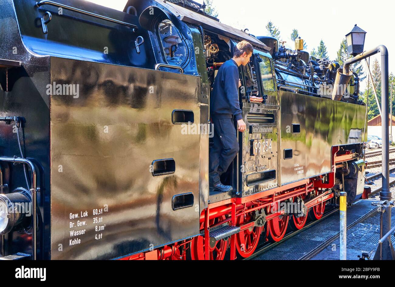 Steam locomotive with train driver at the station Stock Photo - Alamy
