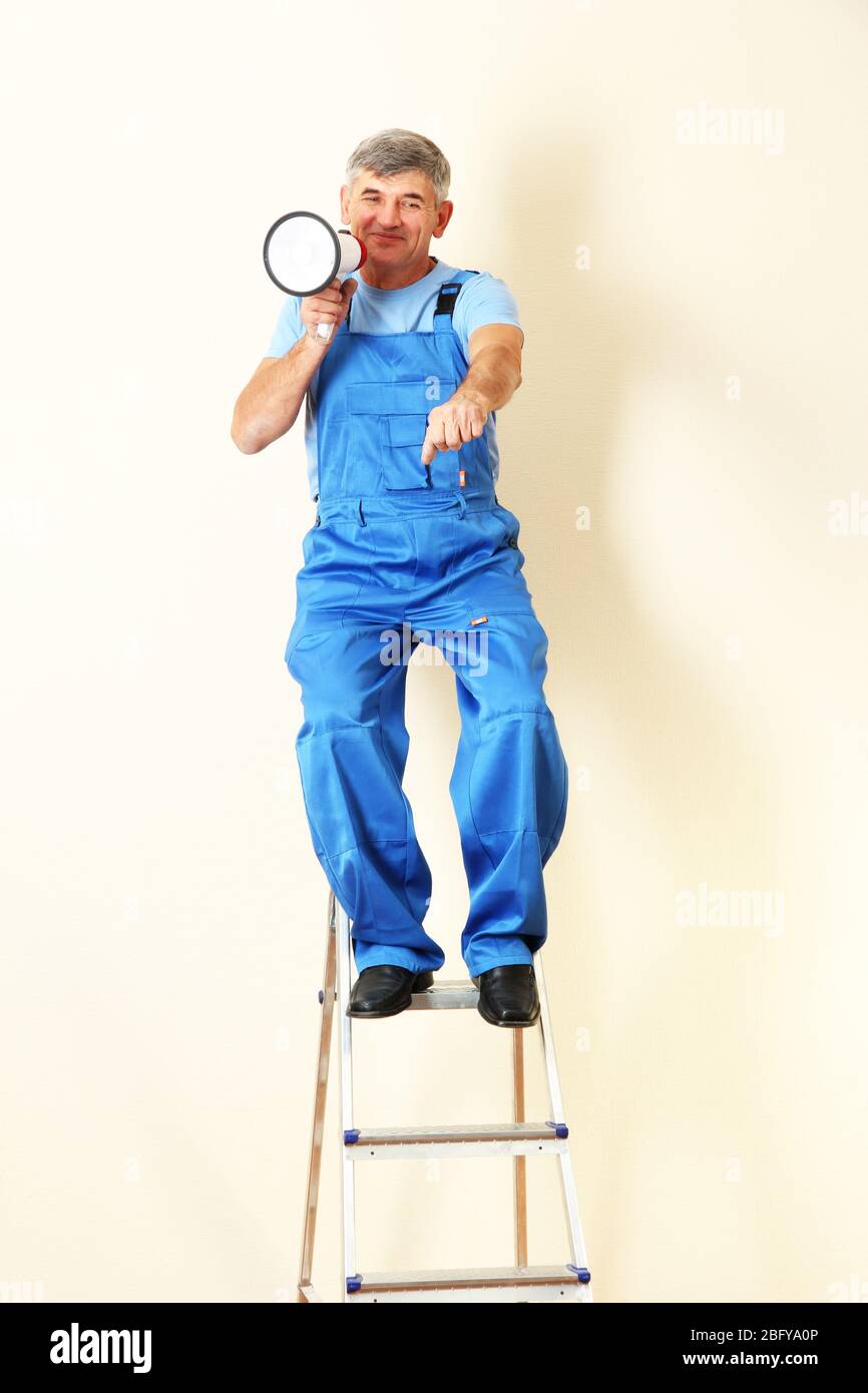Construction superintendent directs repair sitting on ladder Stock ...
