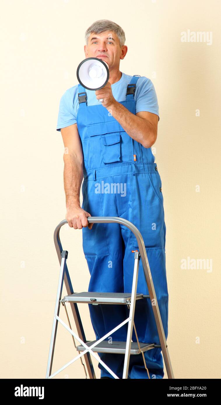 Construction superintendent directs repair standing on ladder Stock ...
