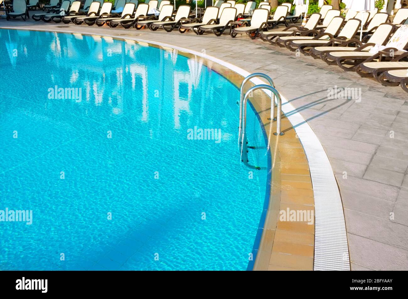 Hotel swimming pool with sunny reflections Stock Photo - Alamy