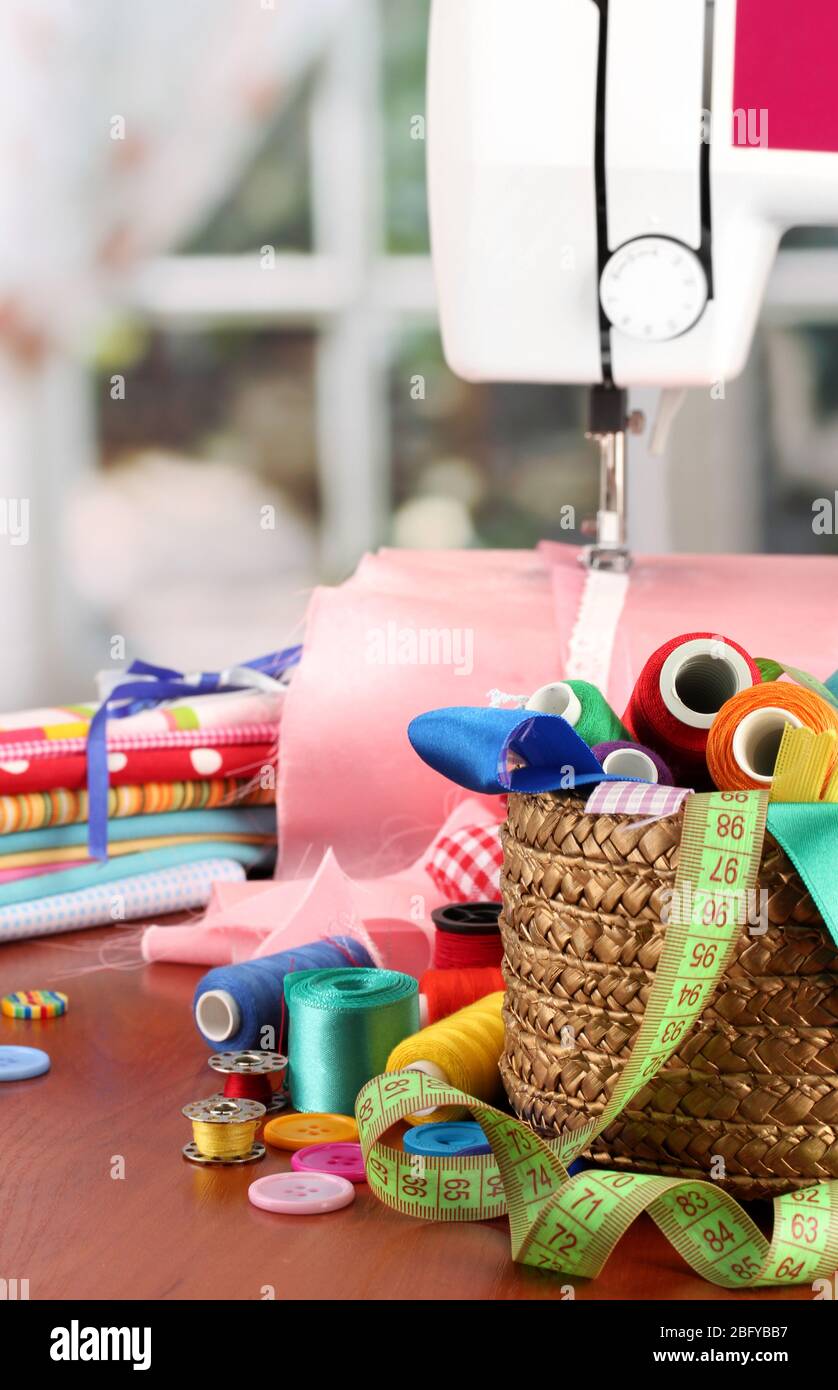 sewing machine and fabric on bright background Stock Photo - Alamy