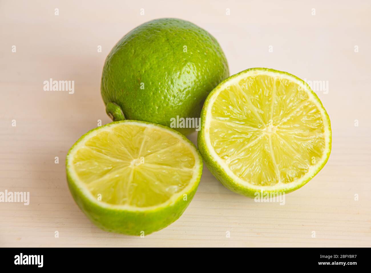 Cut limes on a cutting board Stock Photo - Alamy