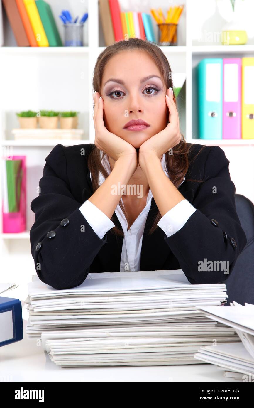 Sad business woman with documents in her workplace Stock Photo - Alamy