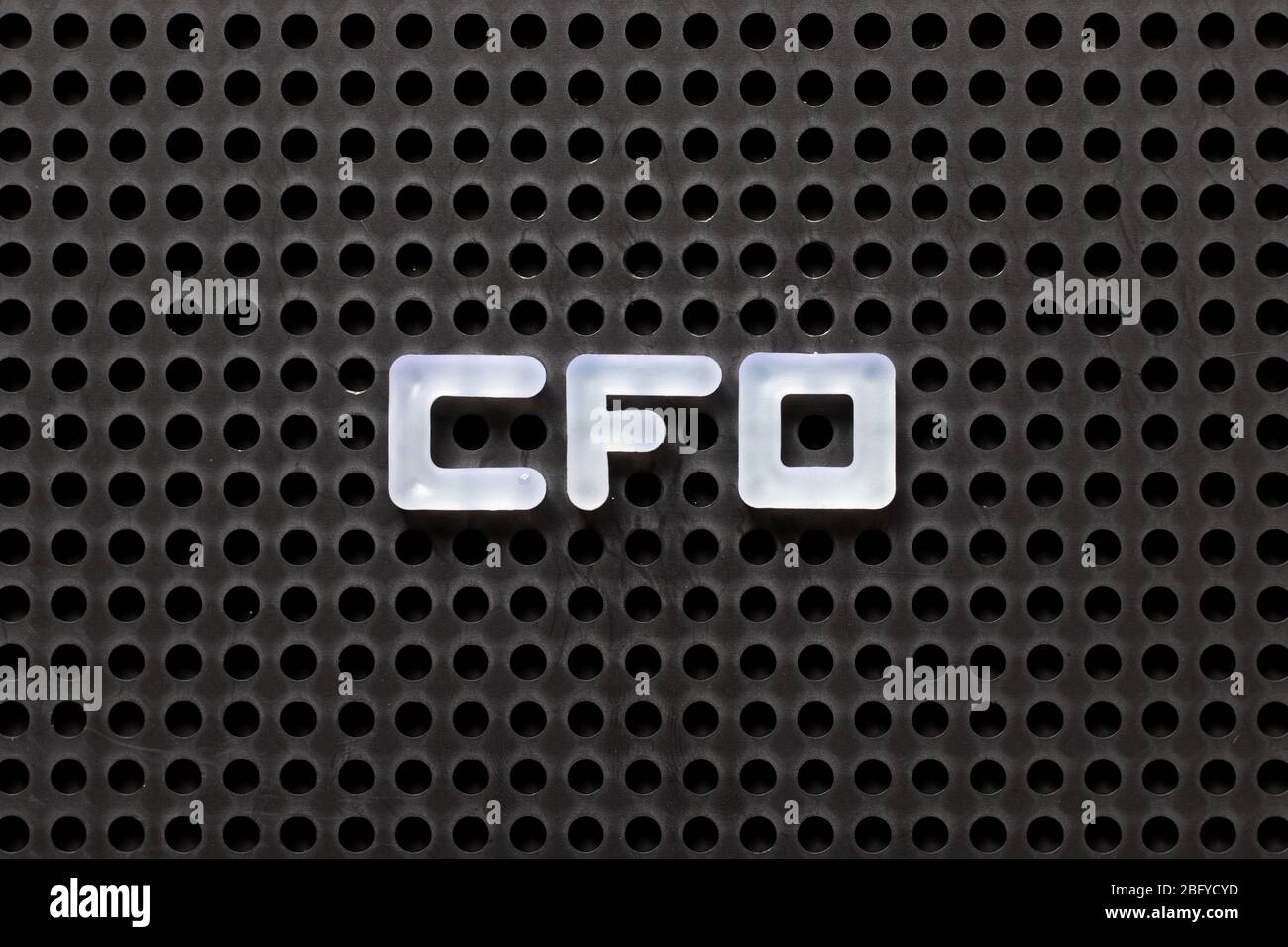 Black color pegboard with white letter in word CFO (Abbreviation of ...