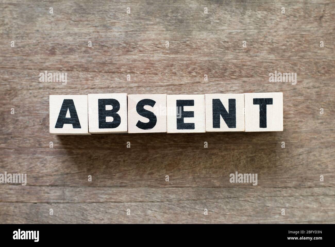 Letter block in word absent on wood background Stock Photo - Alamy