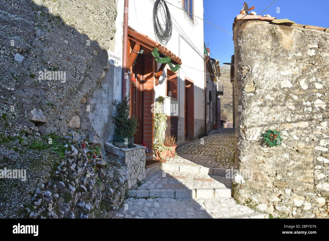 A narrow street between the old houses of Roccamandolfi in the Molise ...