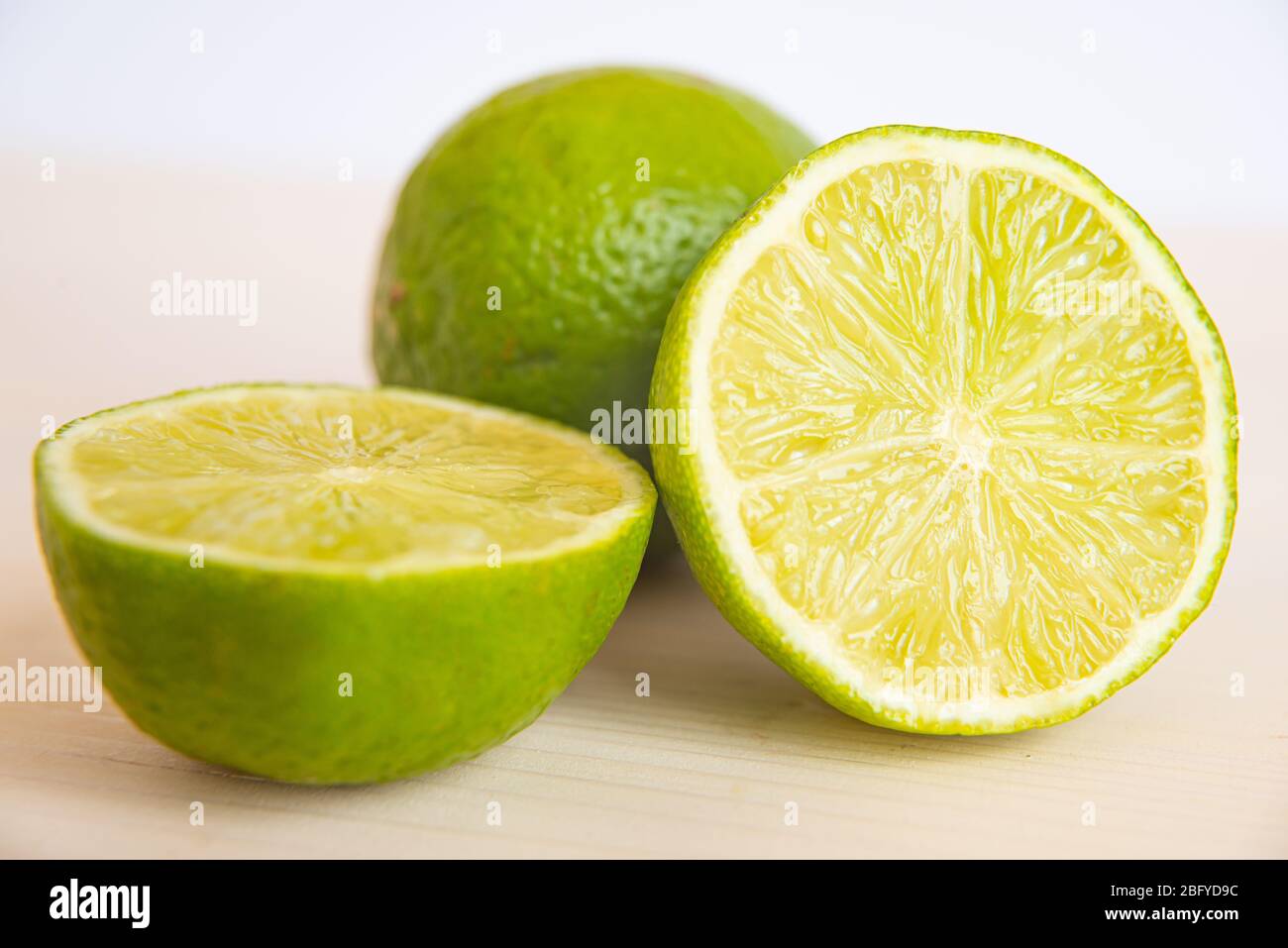 Cut limes on a cutting board Stock Photo - Alamy